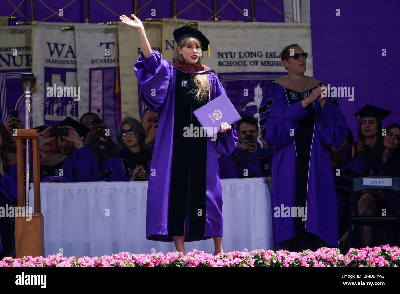 Taylor Swift waves after receiving an honorary degree during a ...