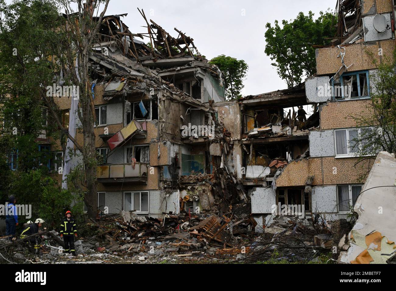 Rescuers work at a site of an apartment building destroyed by Russian ...