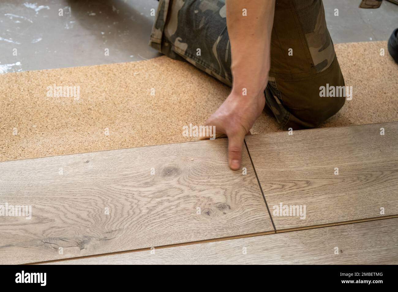 A man lays a laminate floor. Repair in the apartment. Laminate floor ...