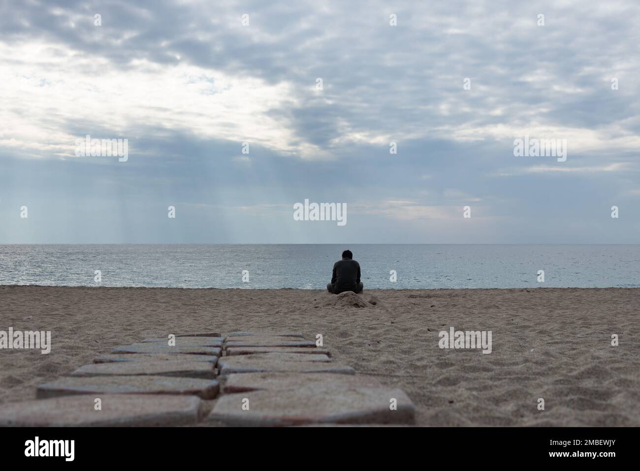 Relaxed man sitting beach looking view hi-res stock photography and ...
