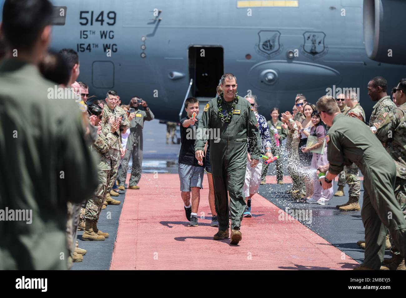 Col. Daniel Dobbels, 15th Wing commander, and his family walk through a ...