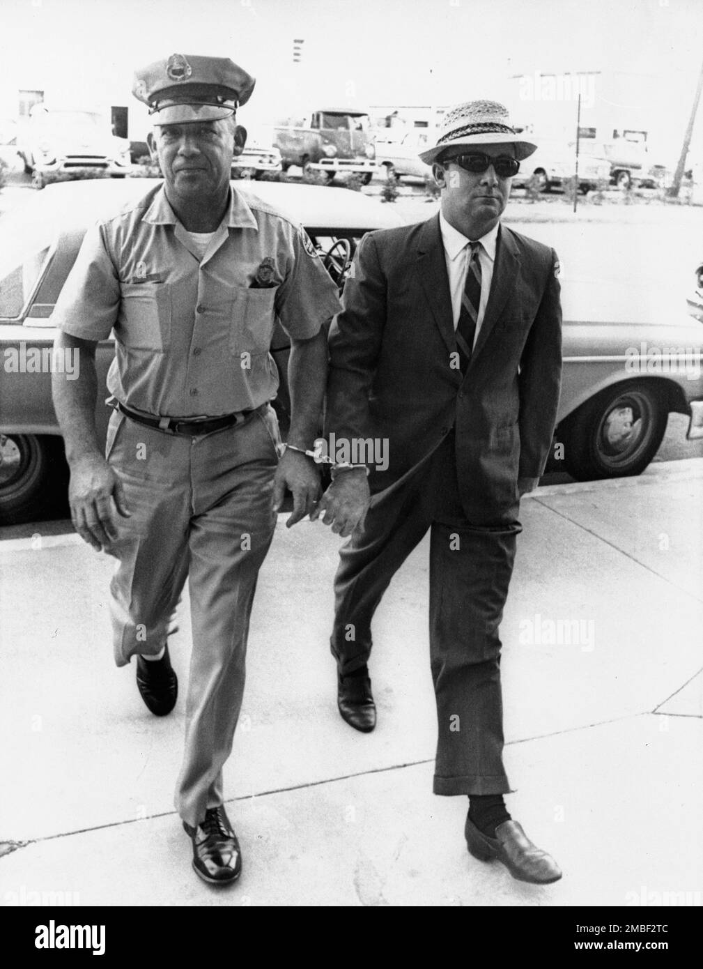 Georges LeMay, 39, right, is lead by a police officer into the new ...