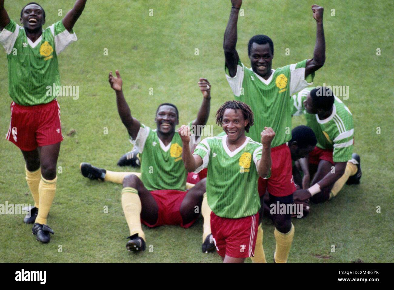 Members of the Cameroon national soccer team raise their arms and ...