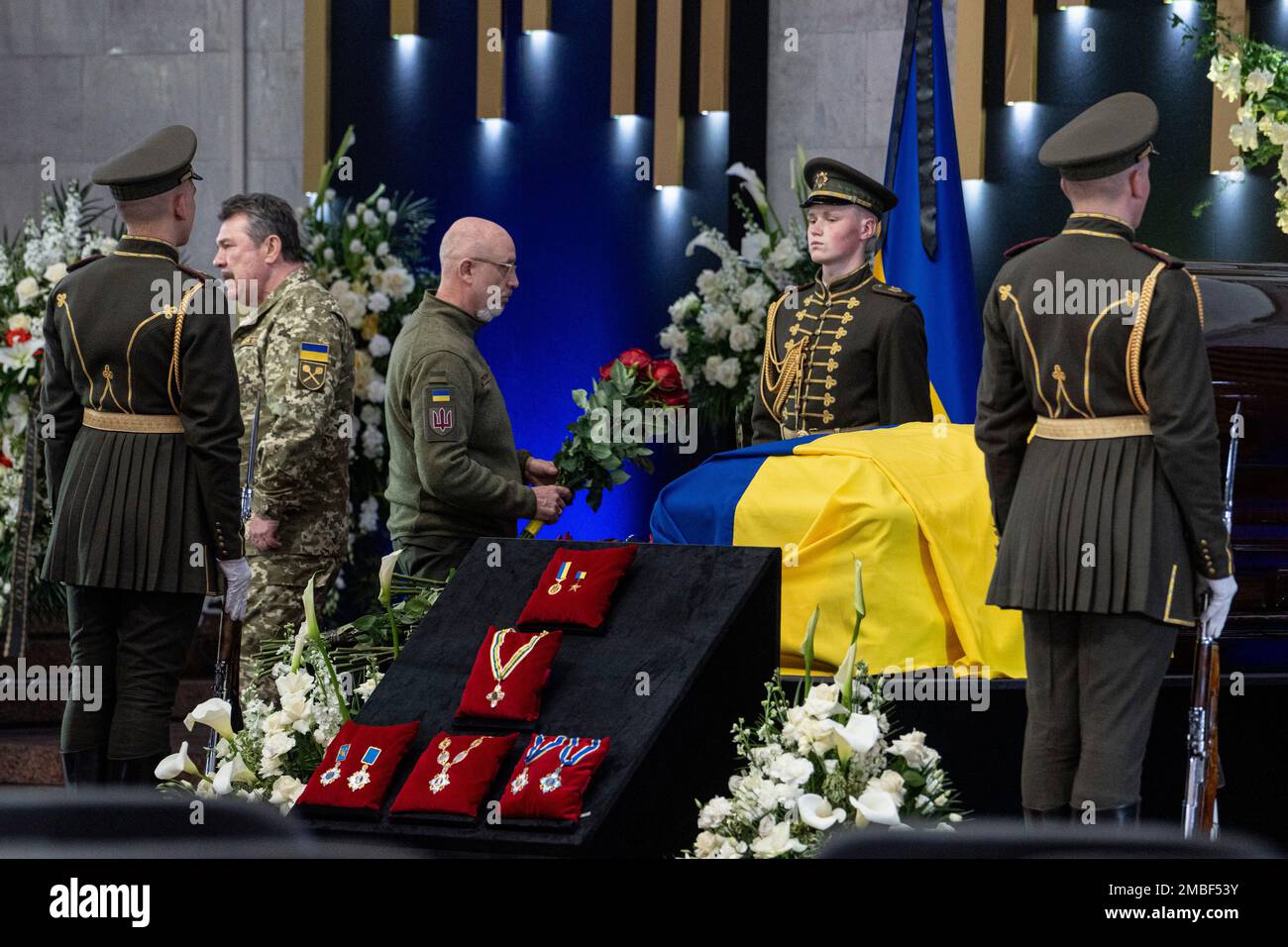 Ukraine's Defense Minister Oleksii Reznikov, center, carries flowers by the coffin of Leonid ...