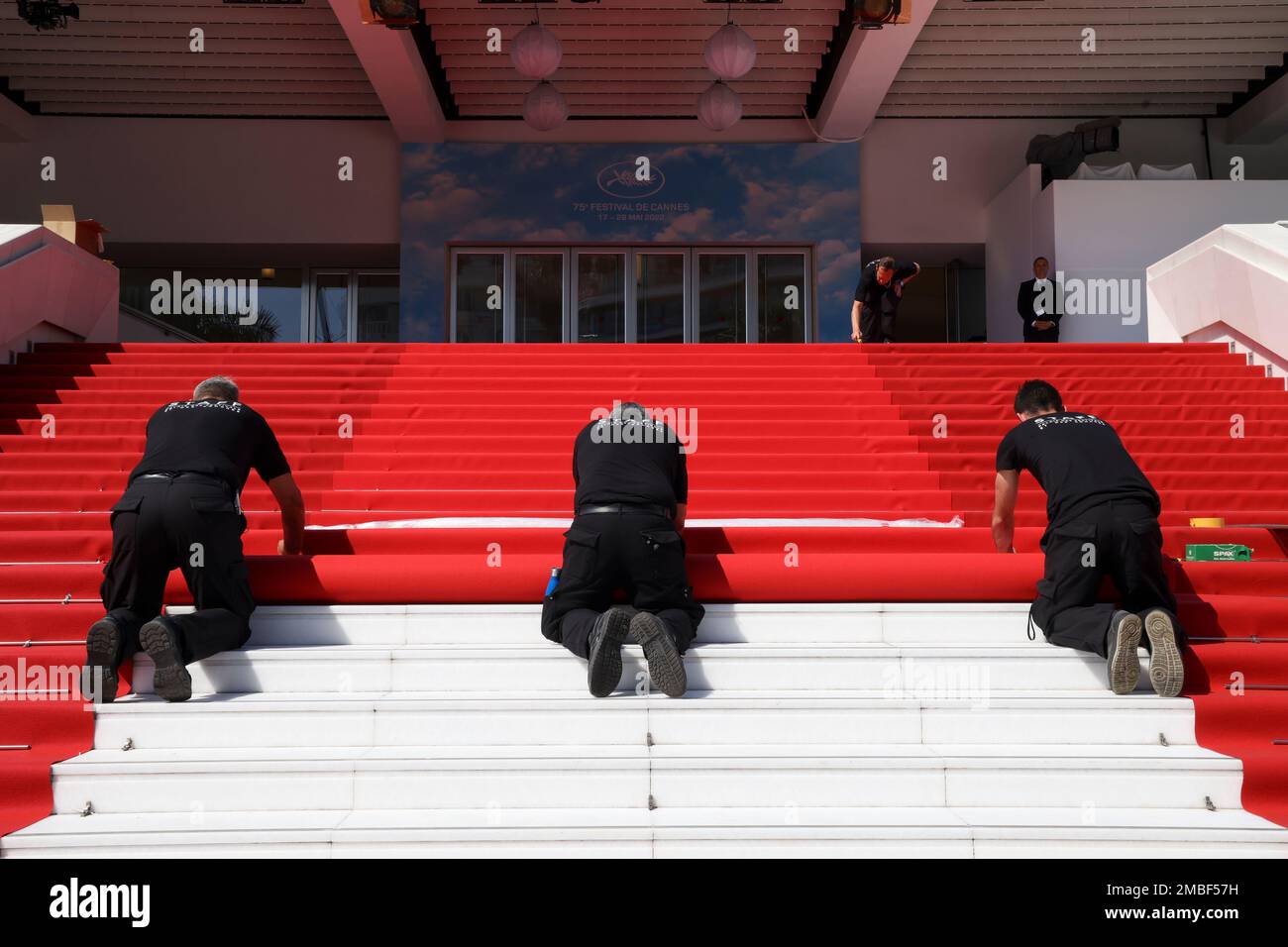 Crew members install the red carpet at the Palais des Festivals on ...