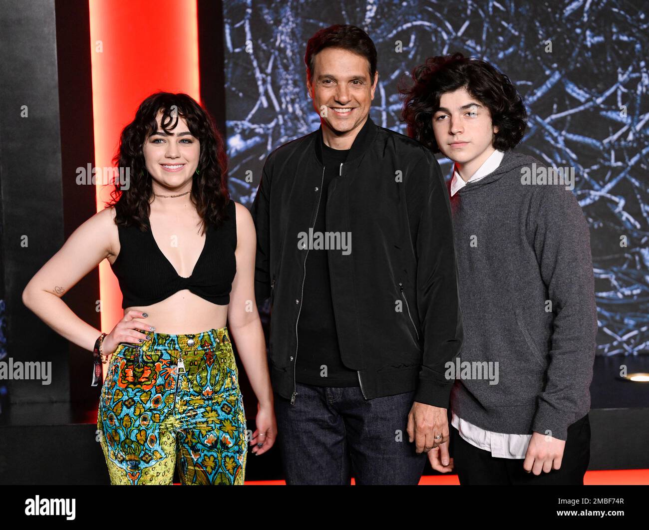 Mary Mouser, left, and Ralph Macchio and Griffin Santopietro attend the ...