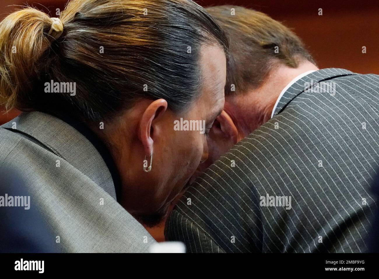 Actor Johnny Depp talks to attorney Ben Chew in the courtroom at the ...