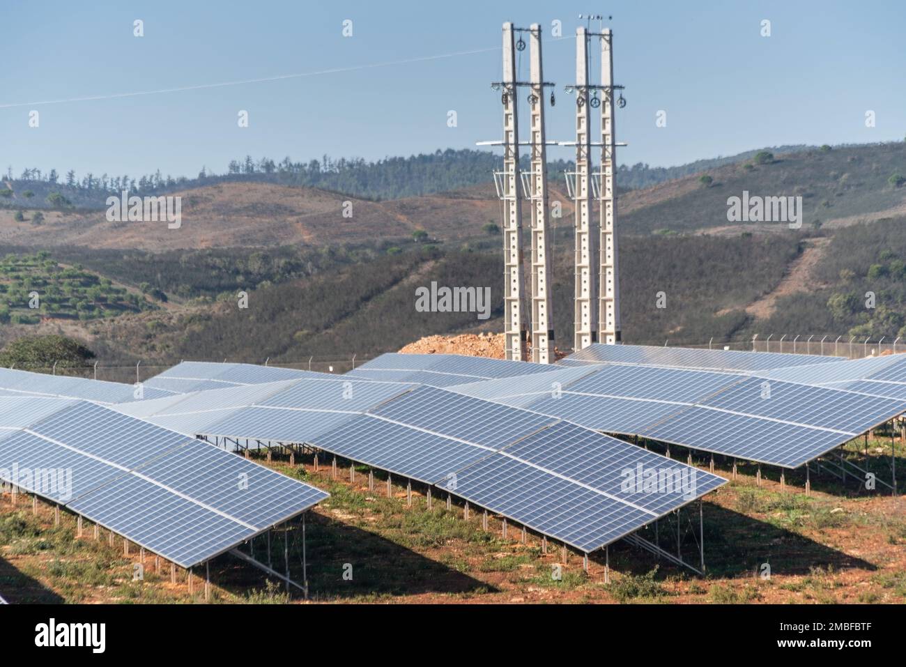 Aerial. Station's solar panels cover fields of Portuguese hills to ...