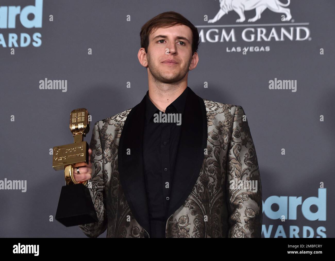 Illenium poses in the press room with the award for top dance ...