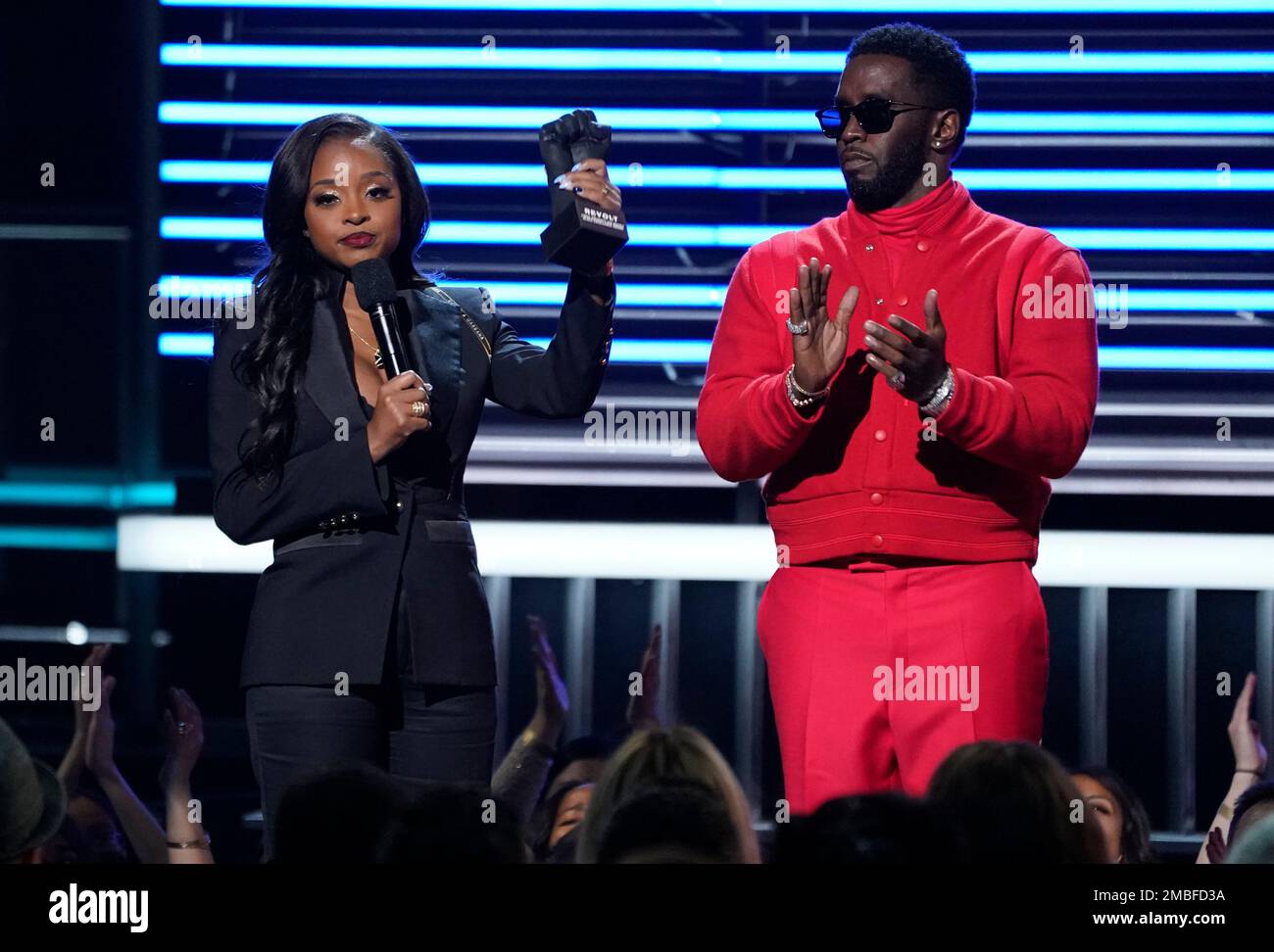Sean "Diddy" Combs, right, presents the revolt black excellence award ...