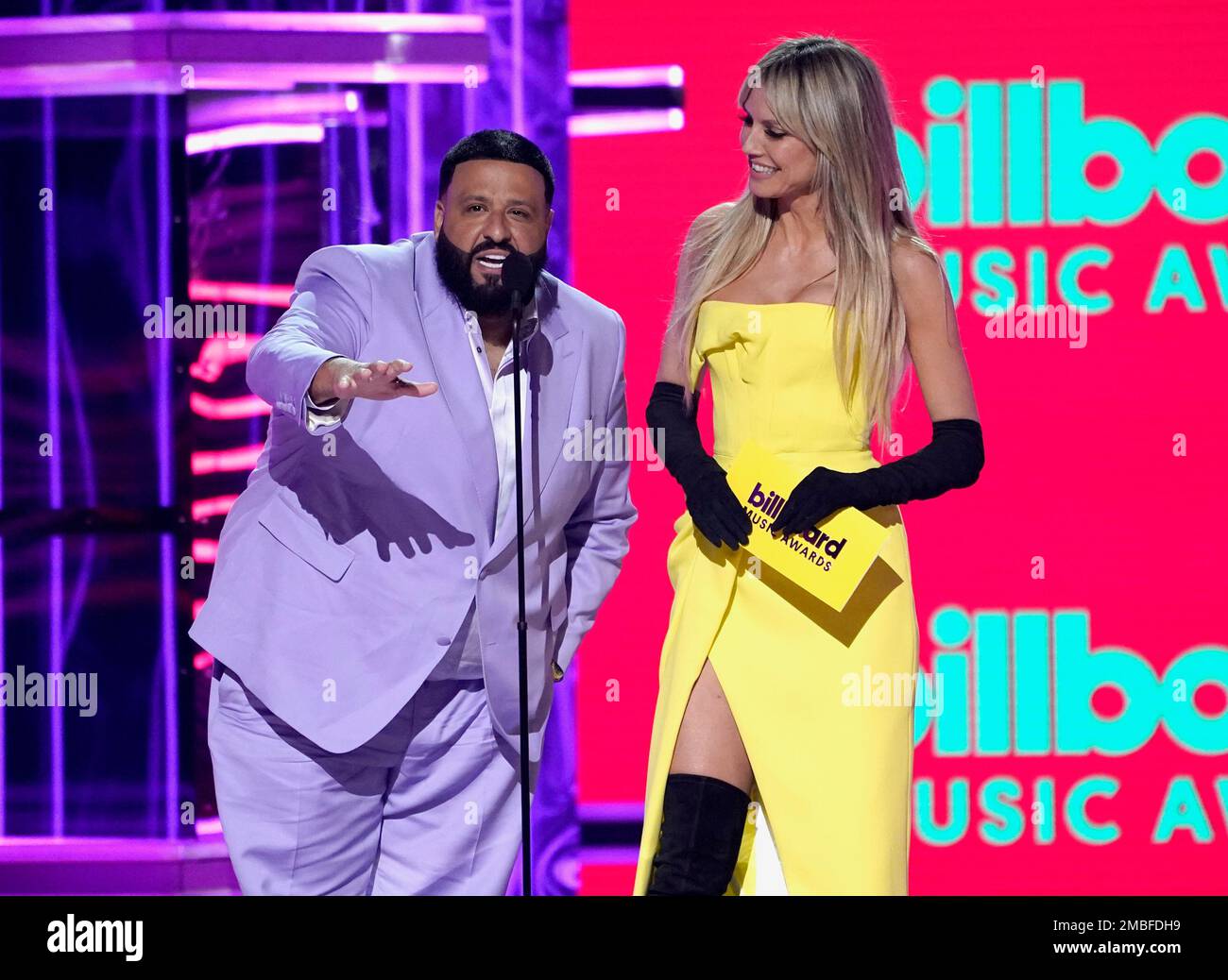 DJ Khaled, left, and Heidi Klum present the award for top rock artist ...