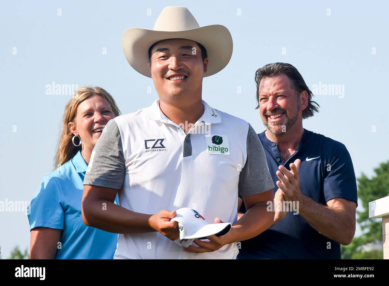 K.H. Lee, of South Korea, smiles after his was given a custom-made ...