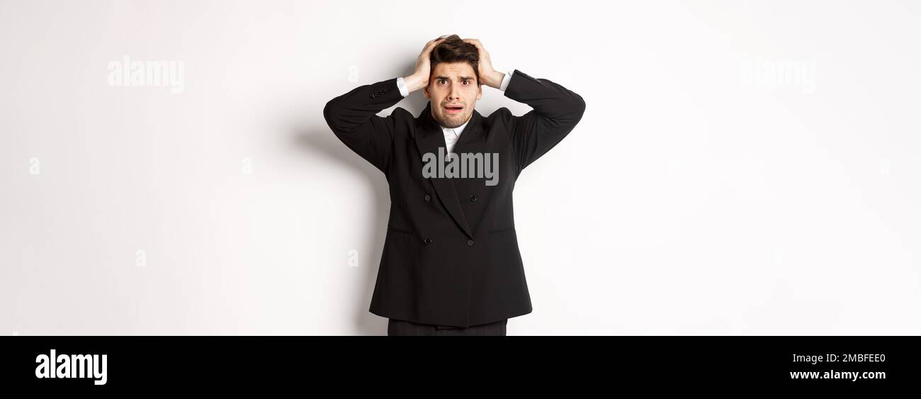 Frustrated and worried businessman in black suit, panicking as looking ...