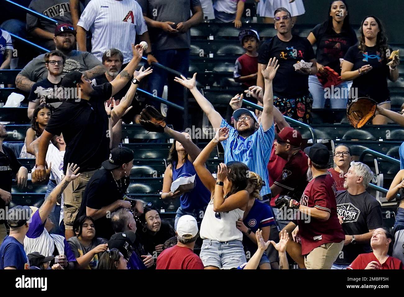 Fans go after a home run hit by Chicago Cubs' Patrick Wisdom during the ...