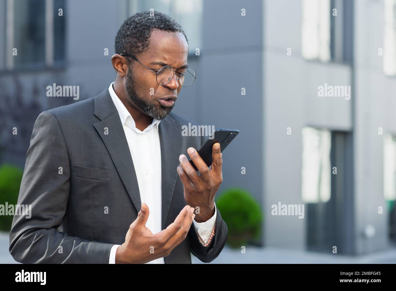 Angry and angry boss talking and shouting on mobile phone, african ...