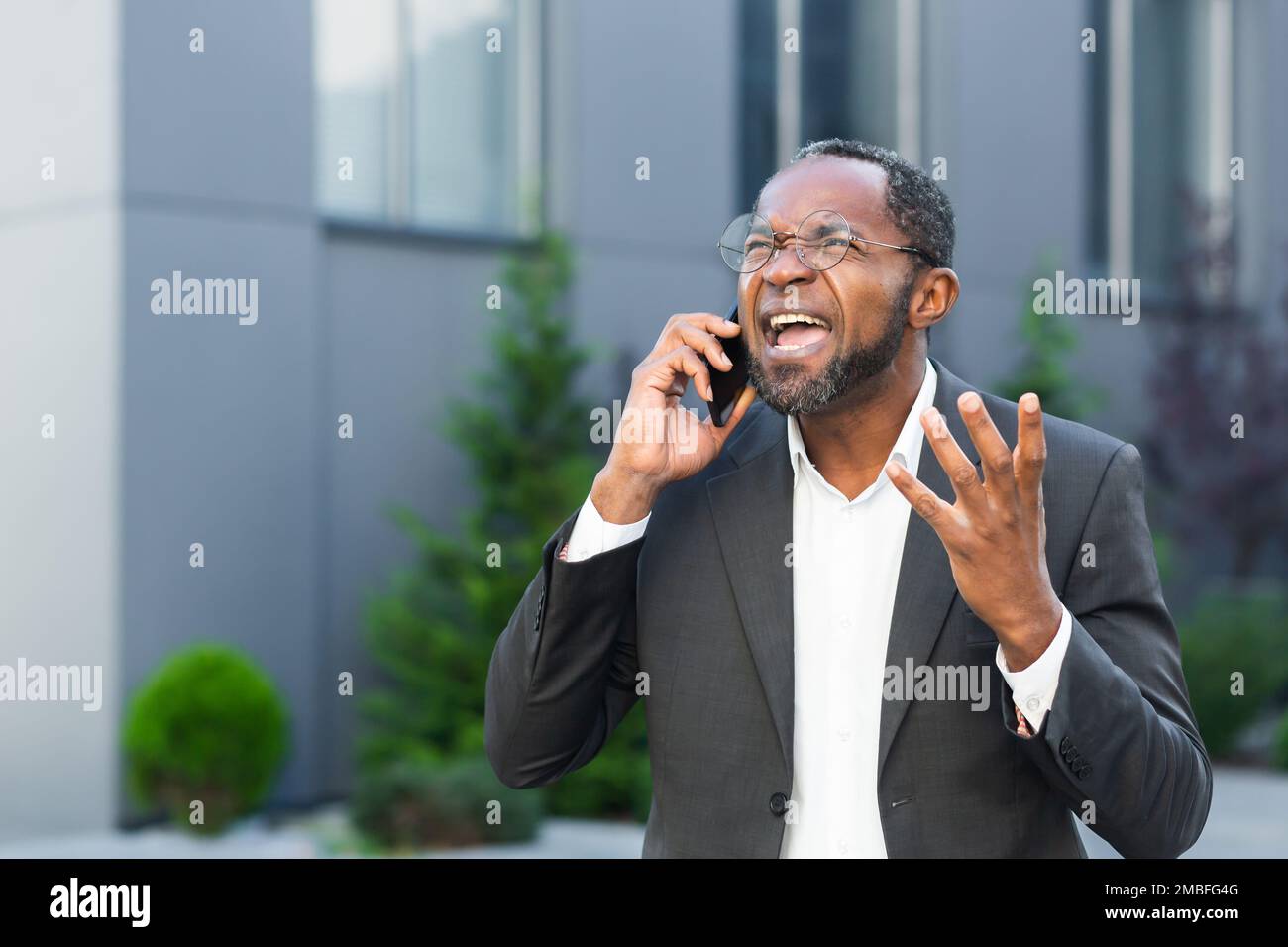 Angry and angry boss talking and shouting on mobile phone, african ...