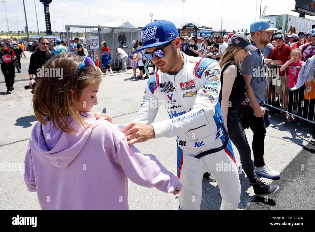 Kyle Larson, center, signs autographs a he heads to pit road before the ...