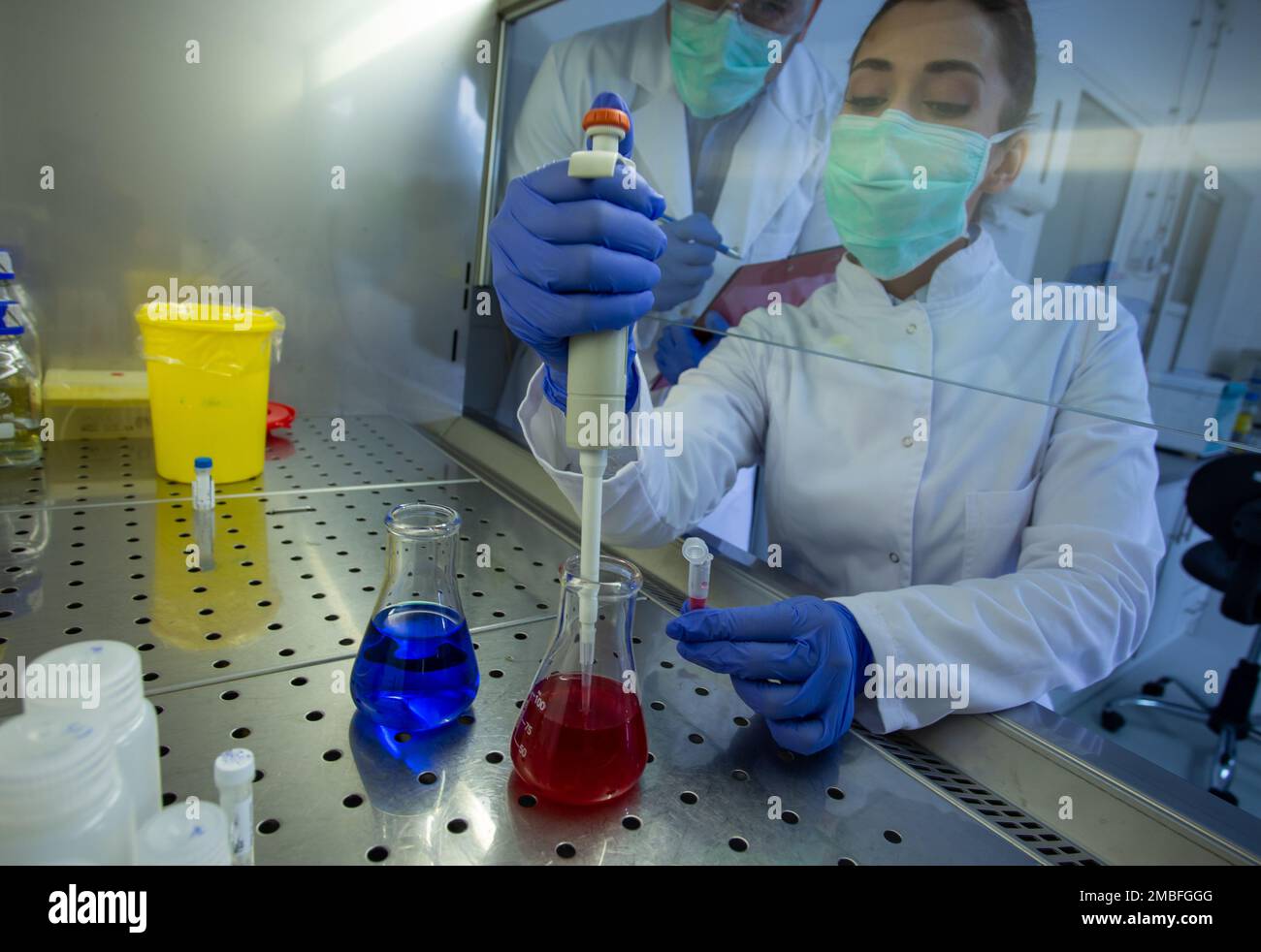 Biologists working in uv glow box in laboratory with chemicals Stock ...