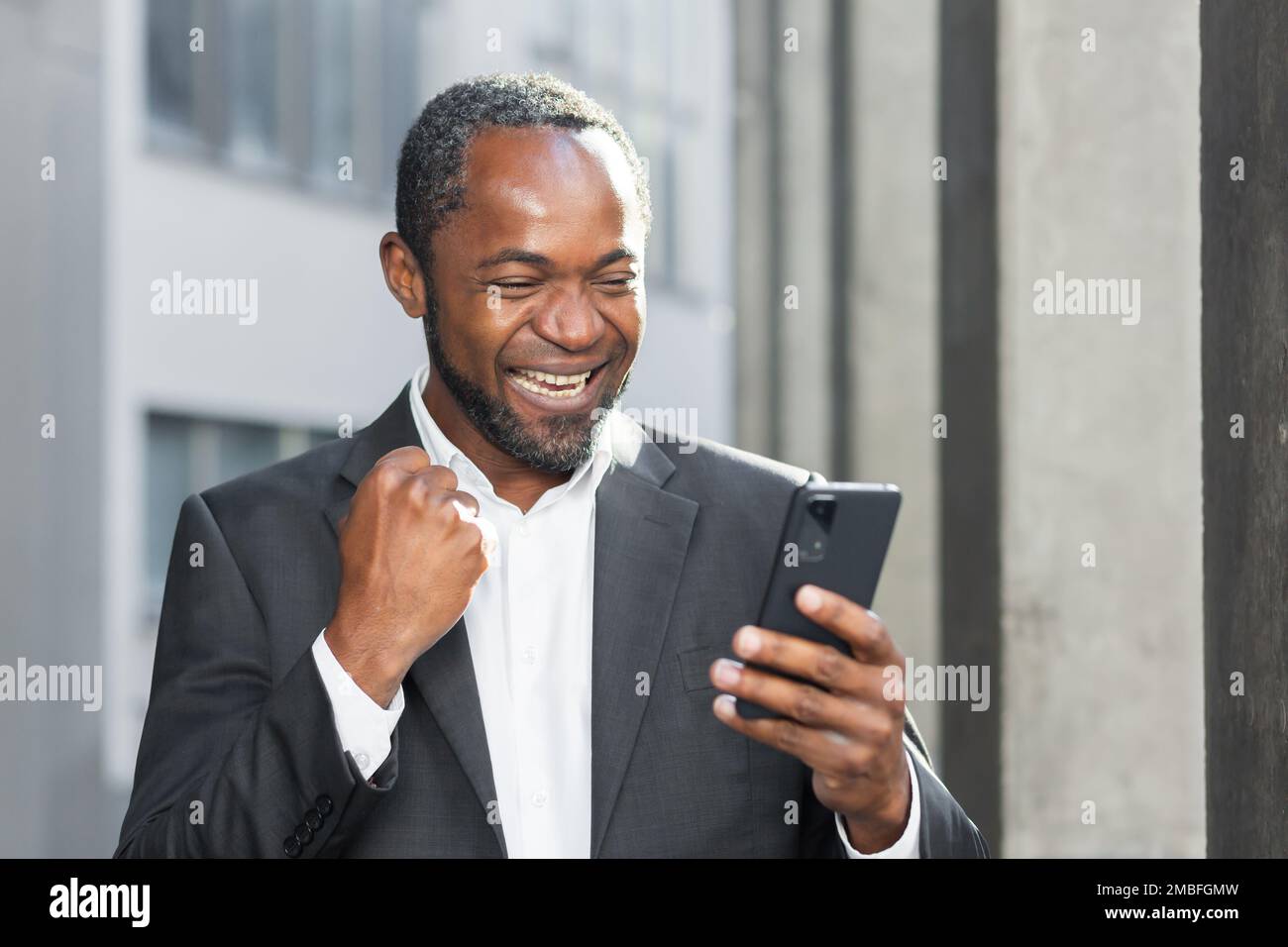 Successful african american boss outside office building using phone ...