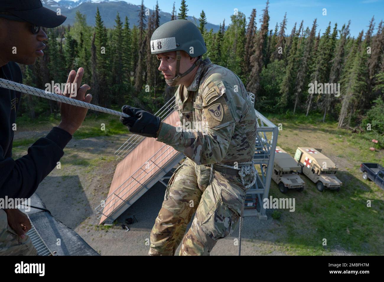 Spc. Caleb Harrington from 11th Airborne Division leans out prior to ...