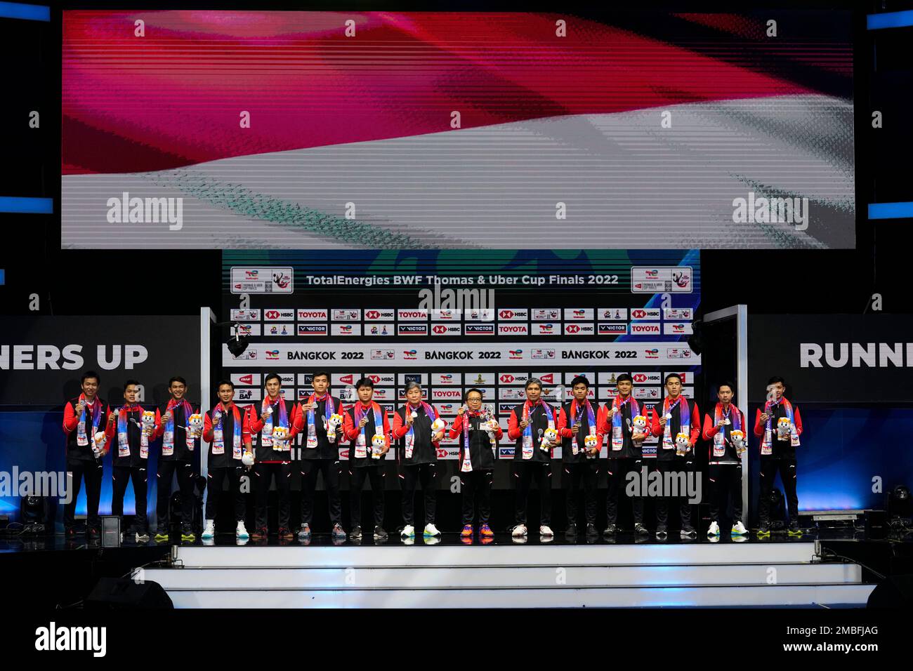 Indonesia's team members hold silver medals during the awards ceremony ...