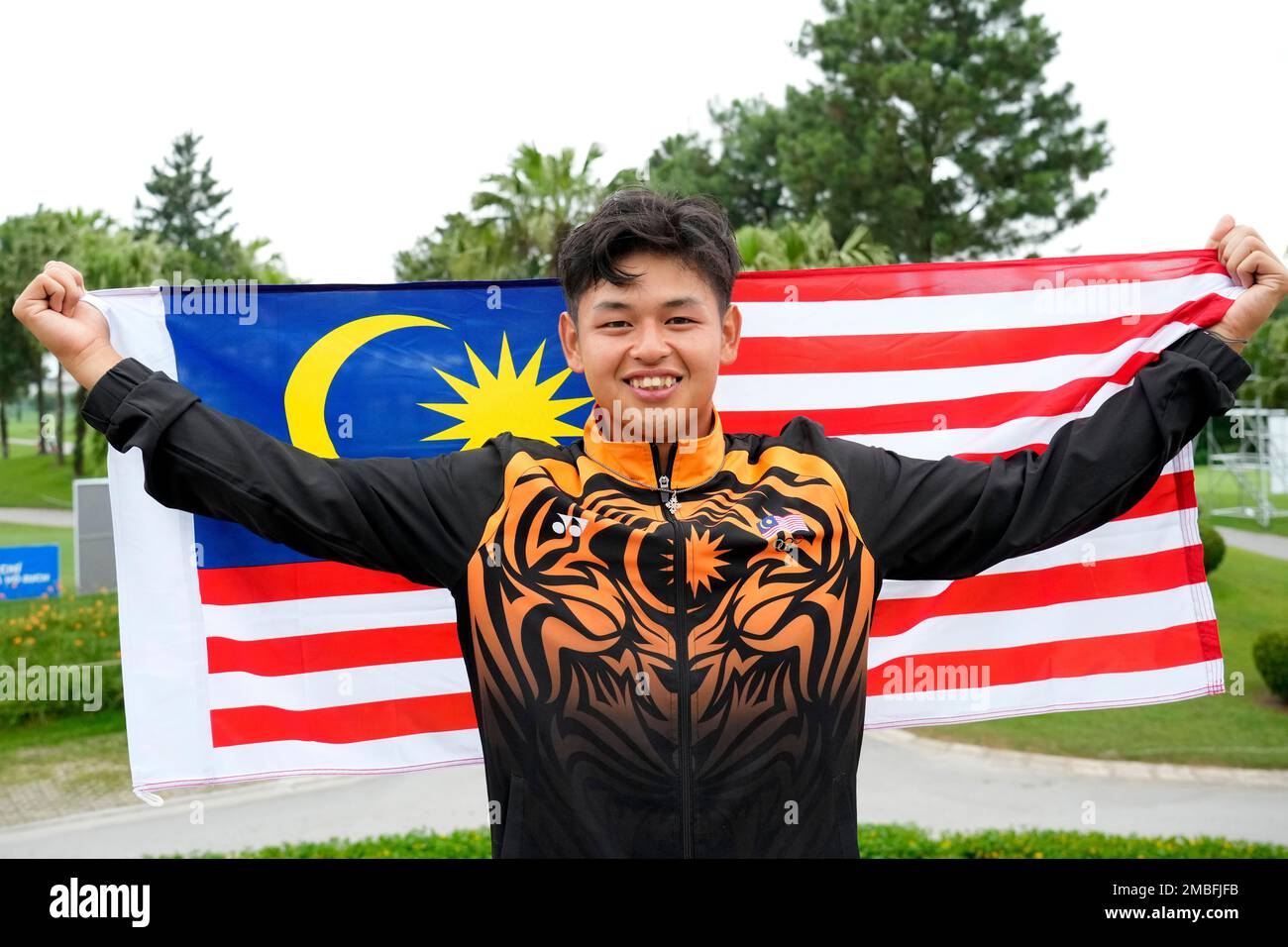 Malaysian Ervin Chang celebrates with the national flag winning the ...