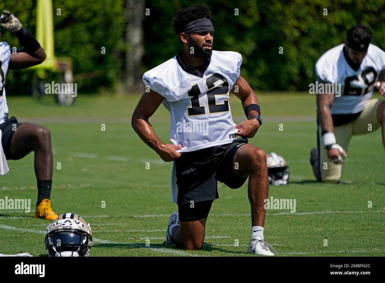 New Orleans Saints wide receiver Chris Olave (12) stretches during the ...