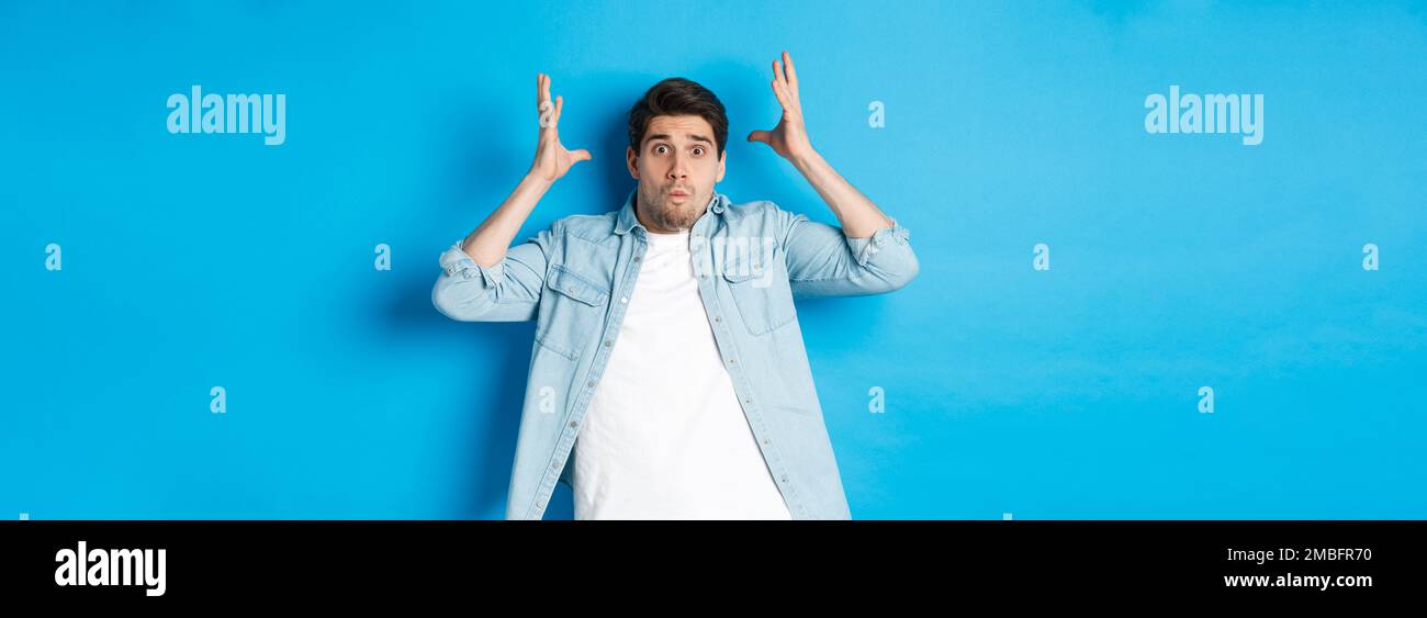 Distressed guy showing mind blowing gesture, looking frustrated and ...