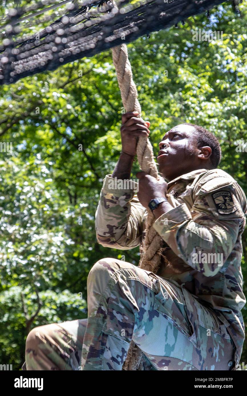A cadet climbs the rope of the tough one obstacle on the obstacle ...