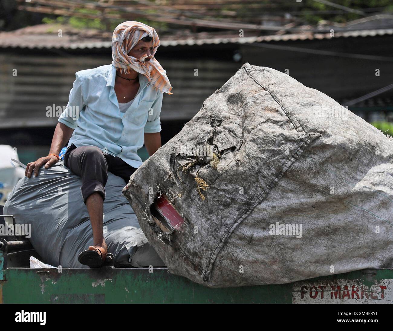 A man covers his face to protect himself from the heat while traveling ...