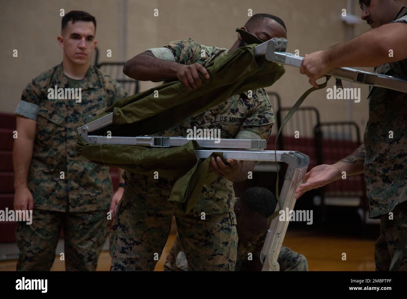 U.S. Marine Corps Cpl. Matheus Stitt, left, supervises the assembly of ...