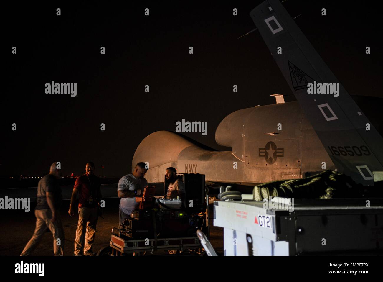 Northrup Grumman contractors perform preflight checks on the last U.S. Navy RQ-4 Global Hawk ...