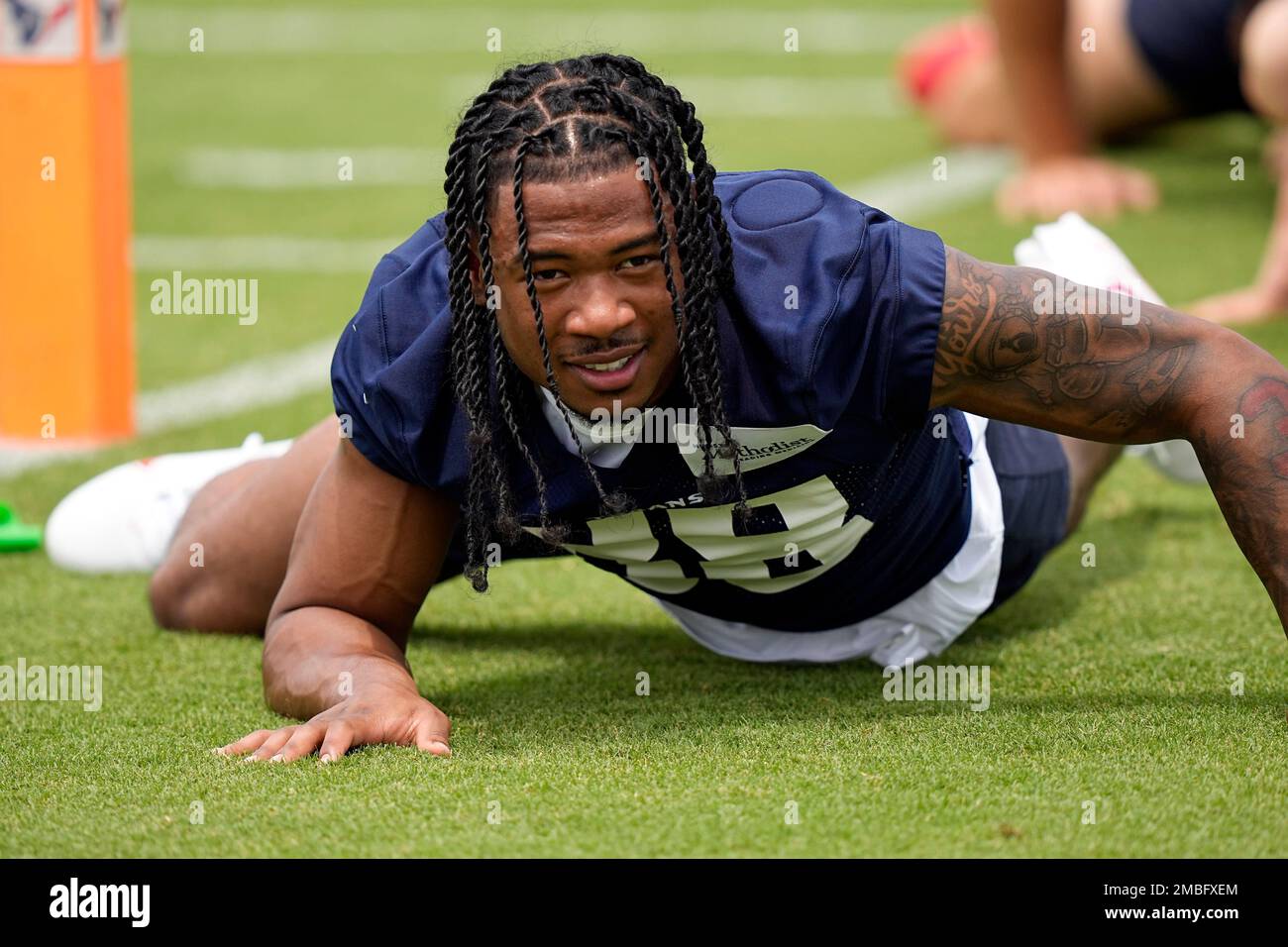 Houston Texans draft pick John Metchie III stretches during an NFL ...