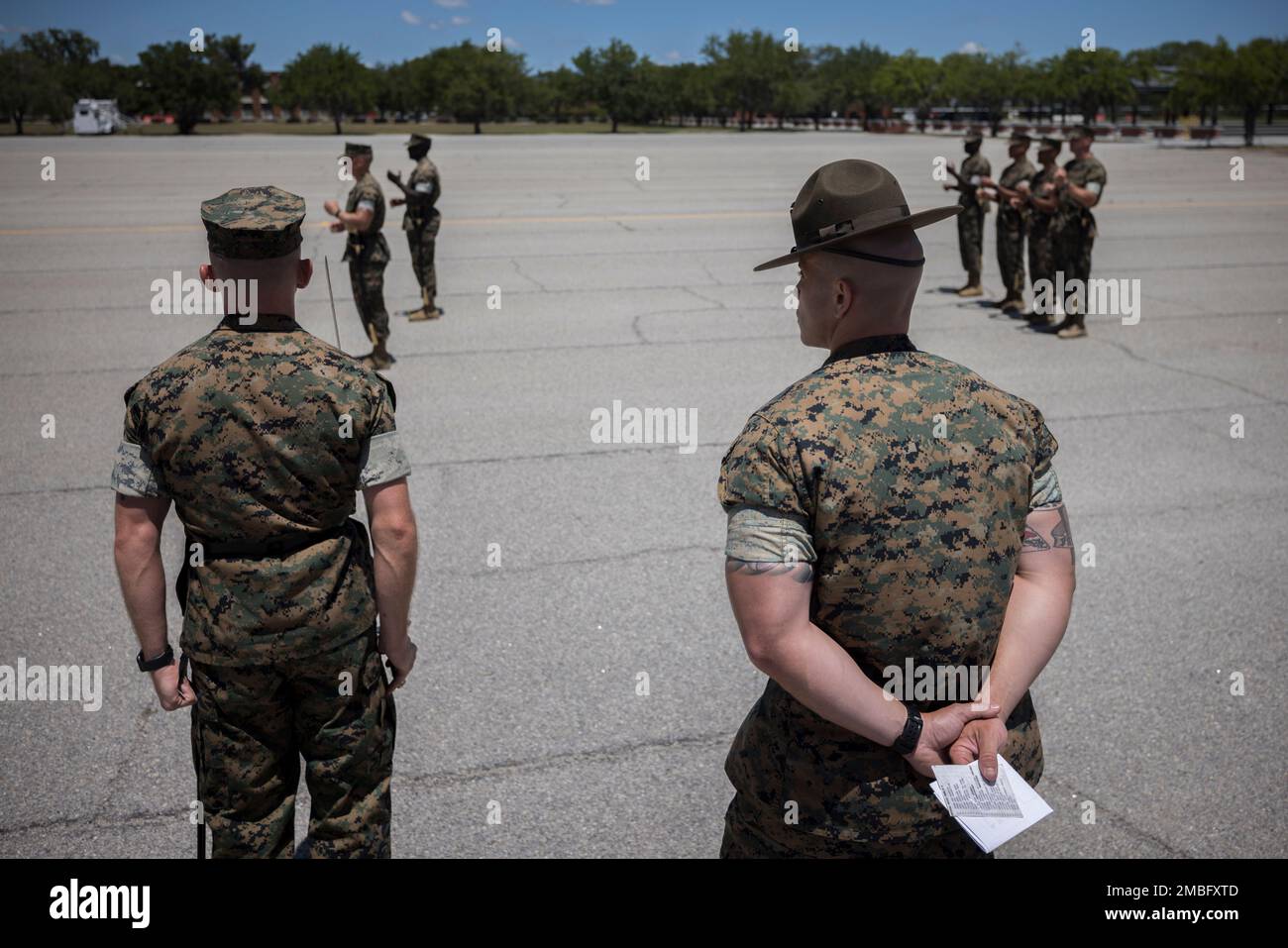 A U.S. Marine Corps drill instructor, right, teaches a group of Marines ...