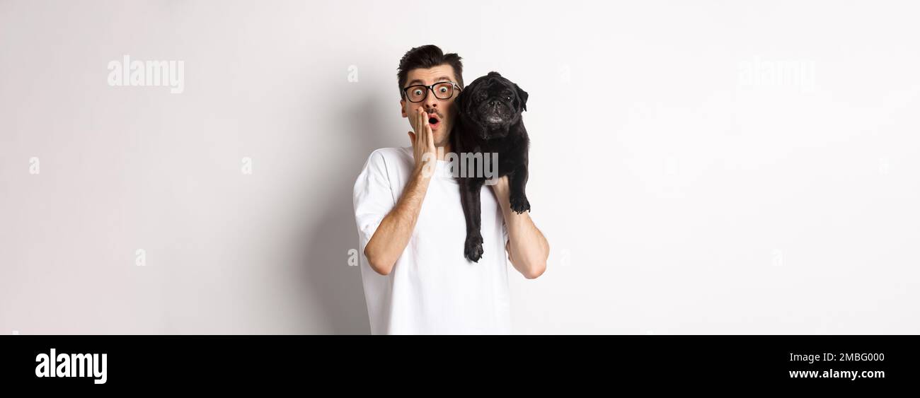 Image of shocked dog owner staring at camera and gasping impressed ...