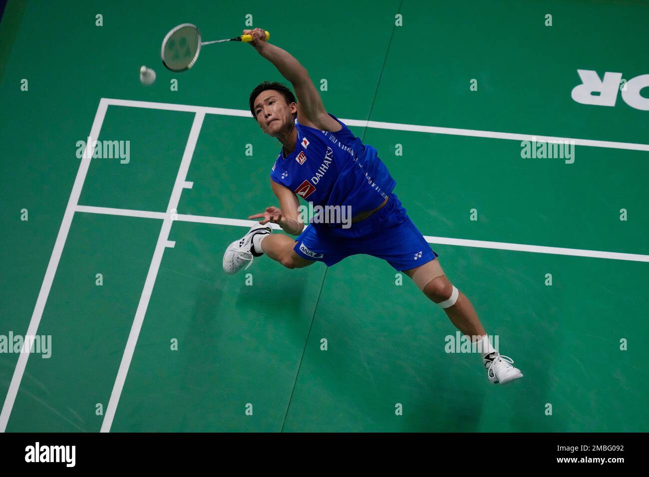 Japan's Kento Momota returns a shot to Indonesia's Anthony Ginting ...