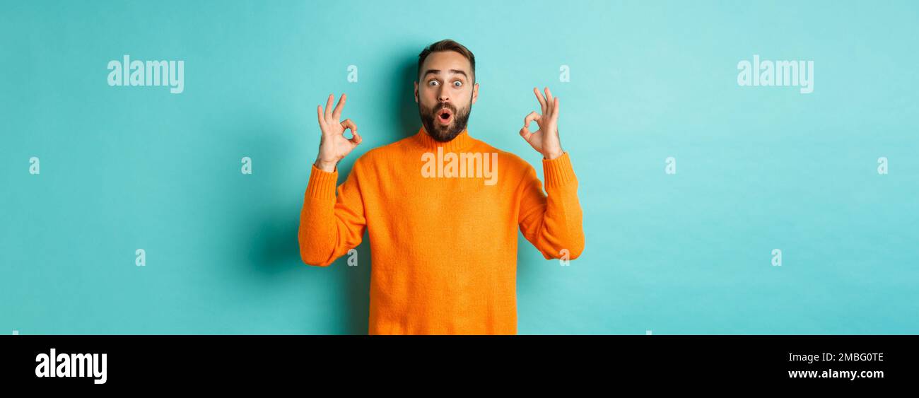 Impressed man praising something super cool, showing okay sign and ...