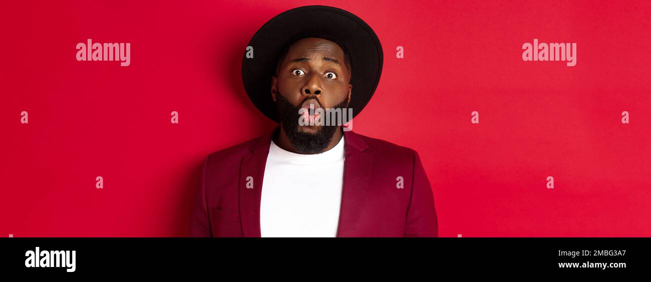 Close-up of surprised Black man staring at camera with wonder, standing ...