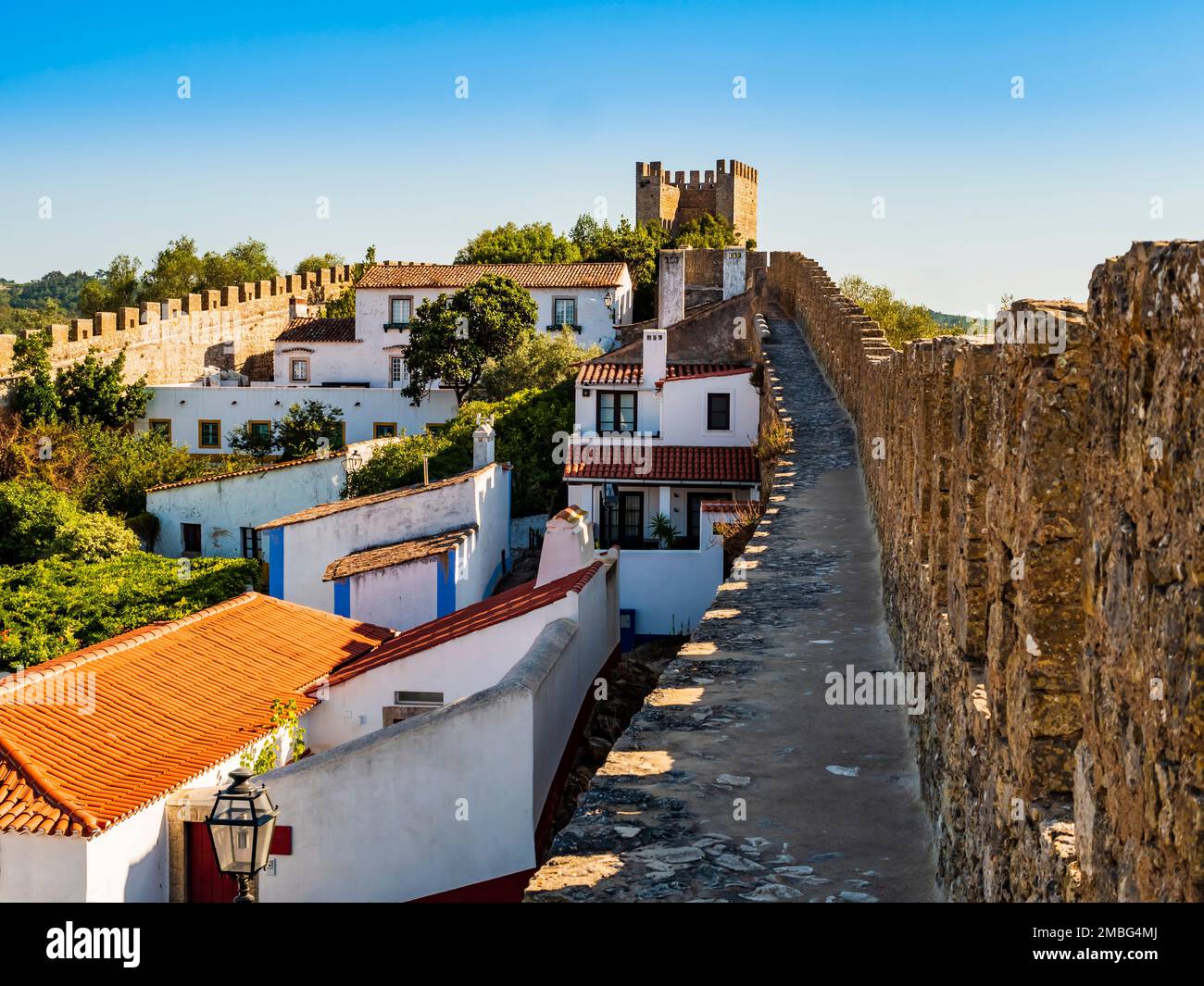 Stunning medieval walls surrounding the whitewashed houses of Obidos ...
