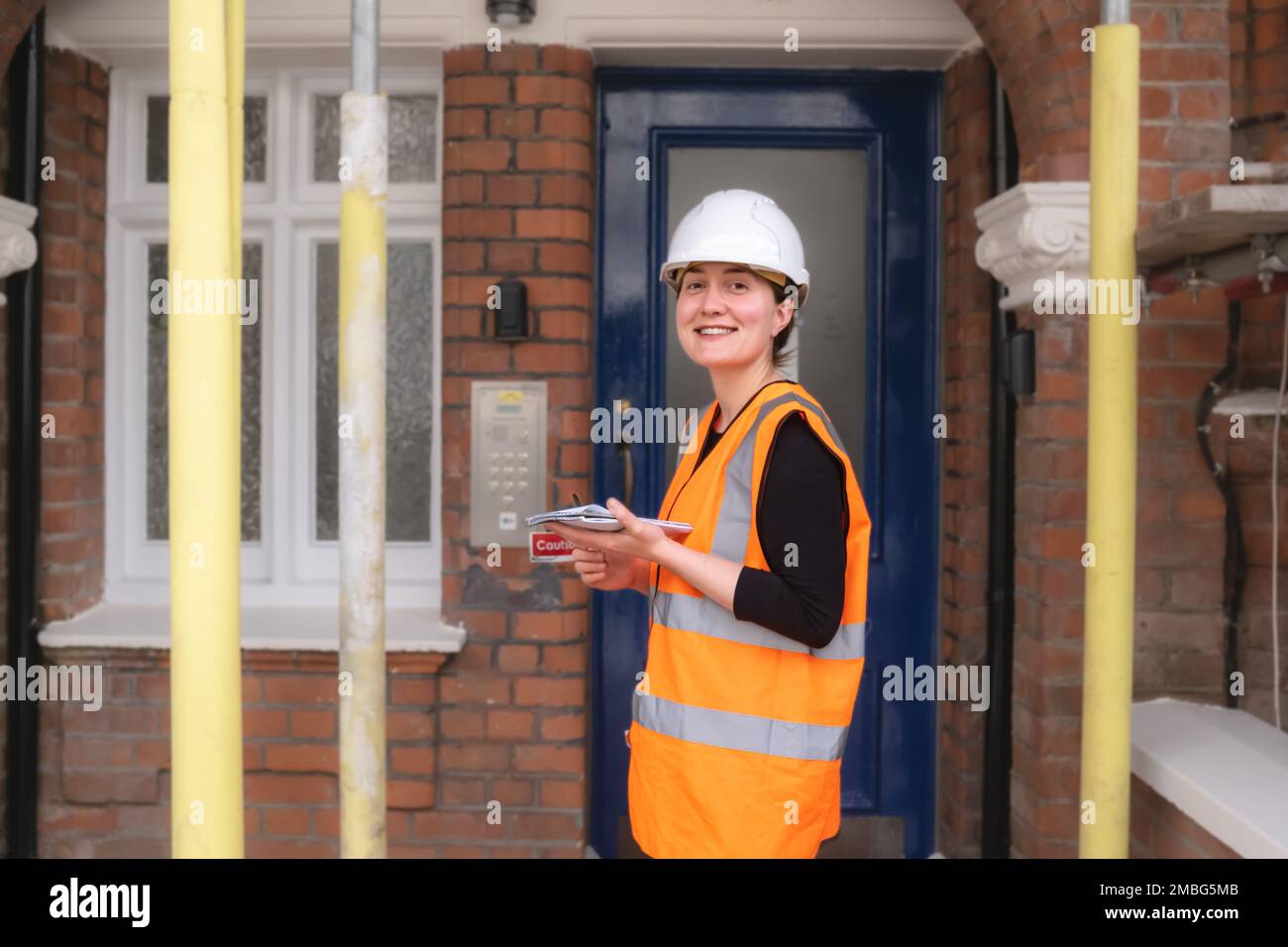 Side view of a smiley civil engineer lady working supervising repair ...