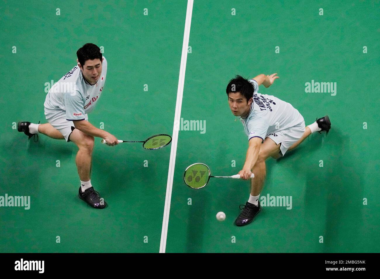 Japan's Yugo Kobayashi, right, with Takuro Hoki, returns the shot to ...