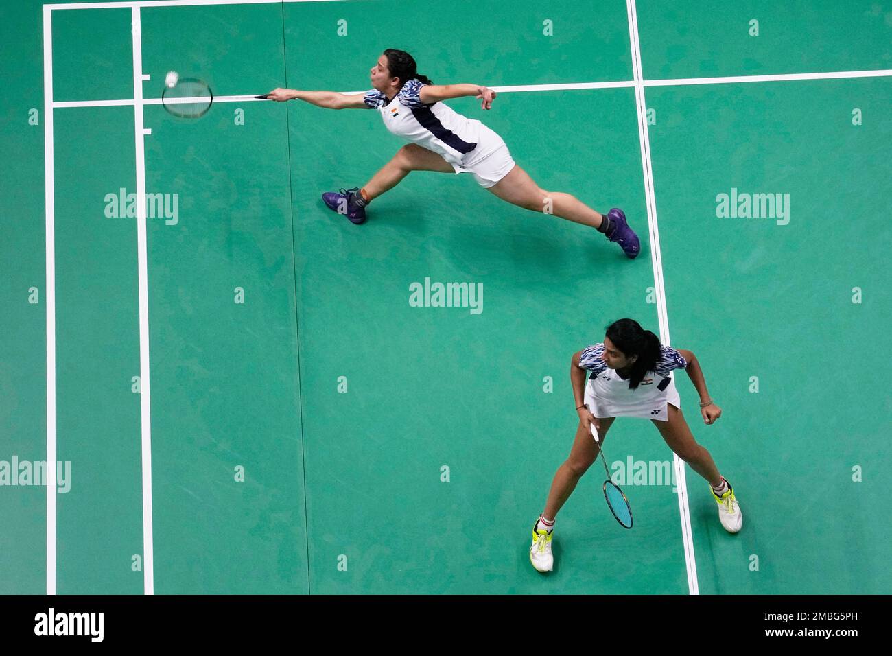India's Shruti Mishra, back, with Simran Singhi, returns the shot to ...