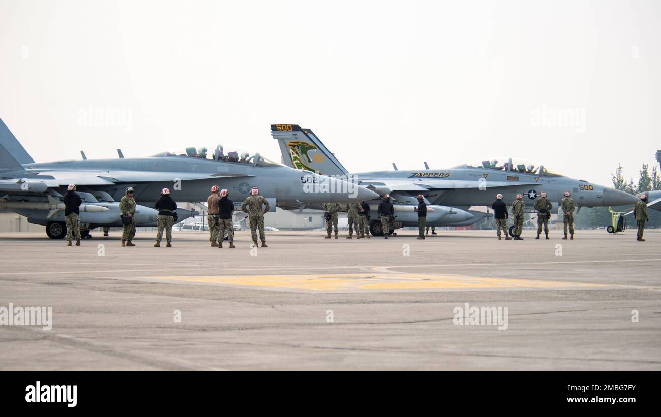 U.S. Navy plane captains help pilots make ready two EA-18G Growlers ...