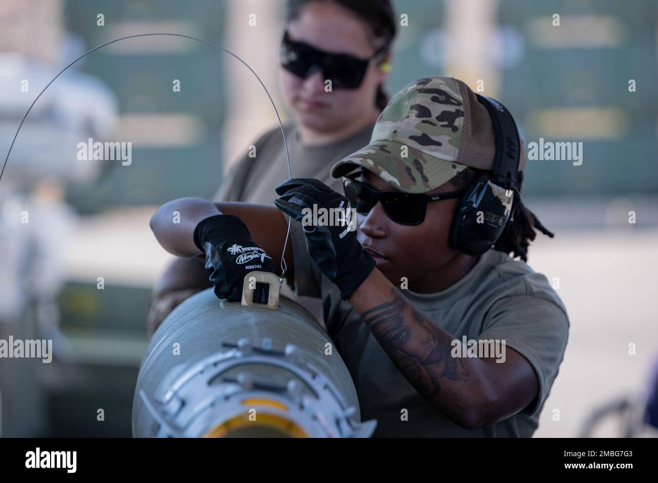 A Munitions Systems specialist secures fuses on live munitions during ...