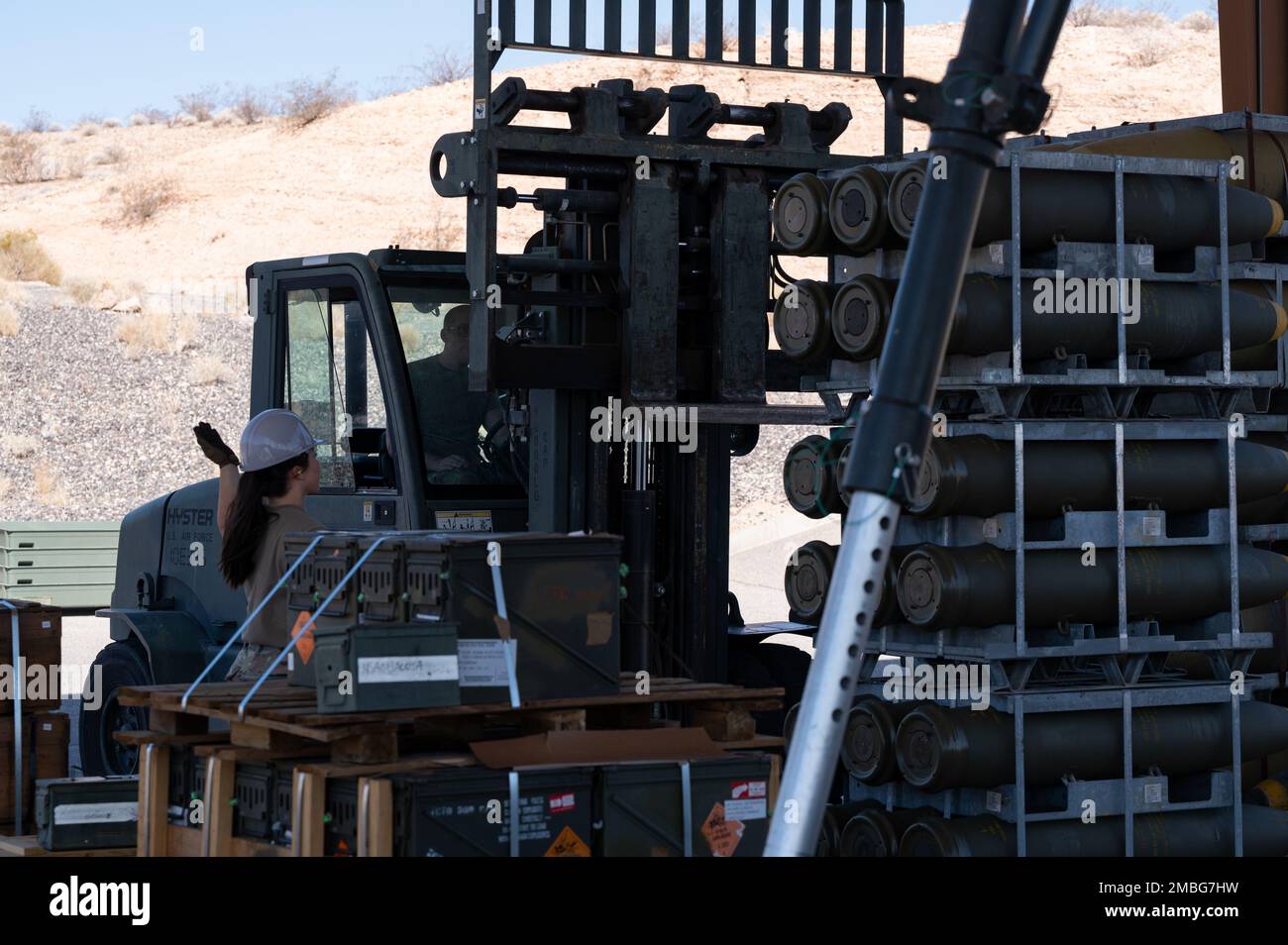 Munitions Systems specialist work together to transport pieces of live ...