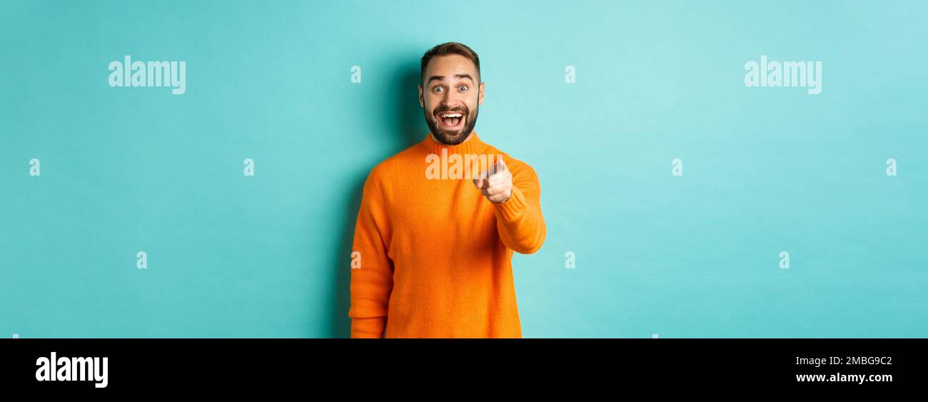 Surprised man stare happy and pointing at camera, recognize someone ...