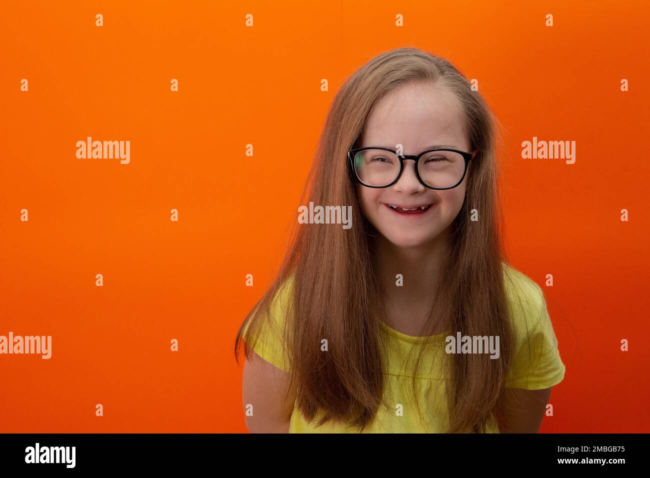 Happy girl with Down syndrome. Having fun, laughing. Funny pigtails ...