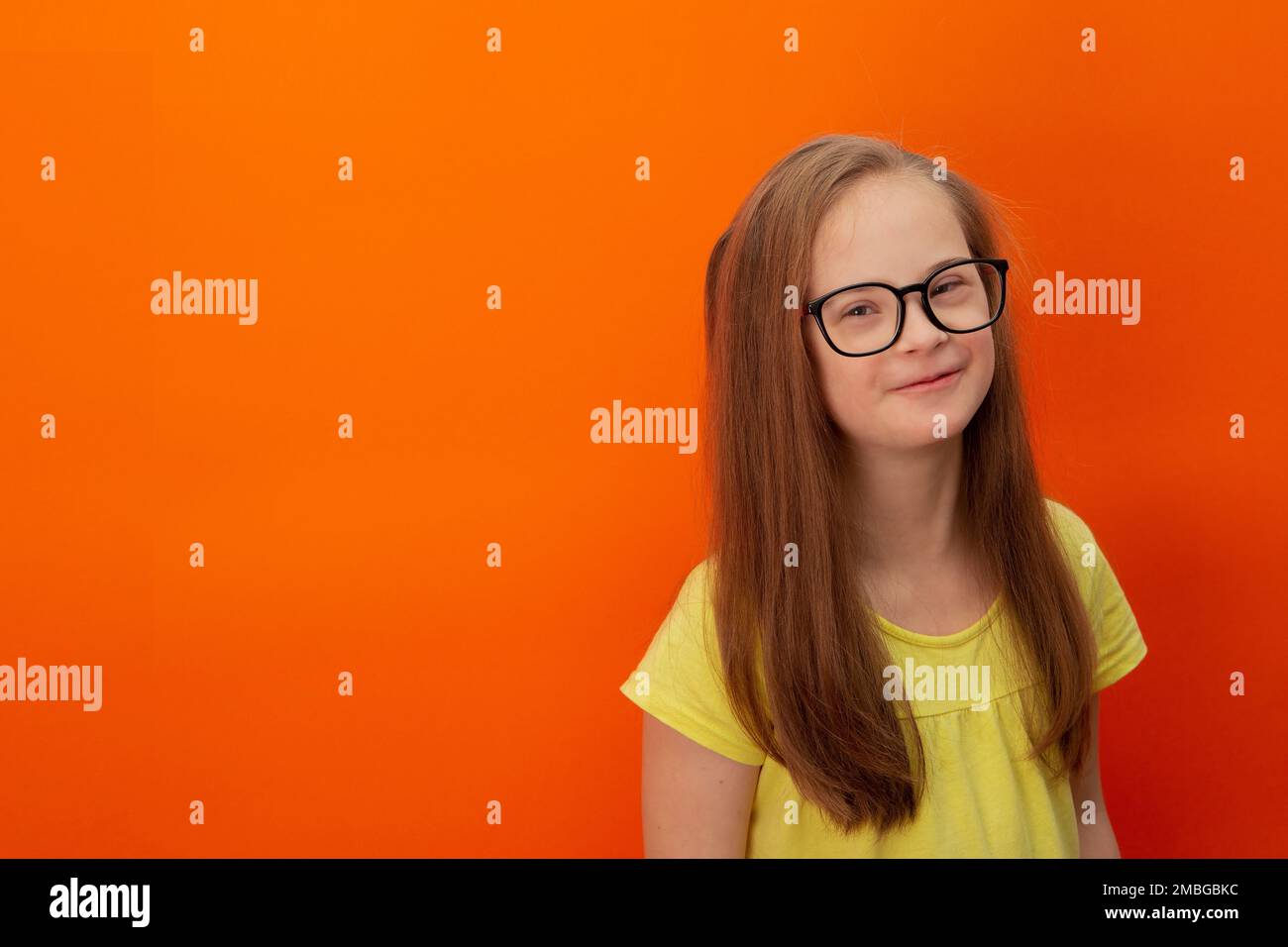 Happy girl with Down syndrome. Having fun, laughing. Funny pigtails ...