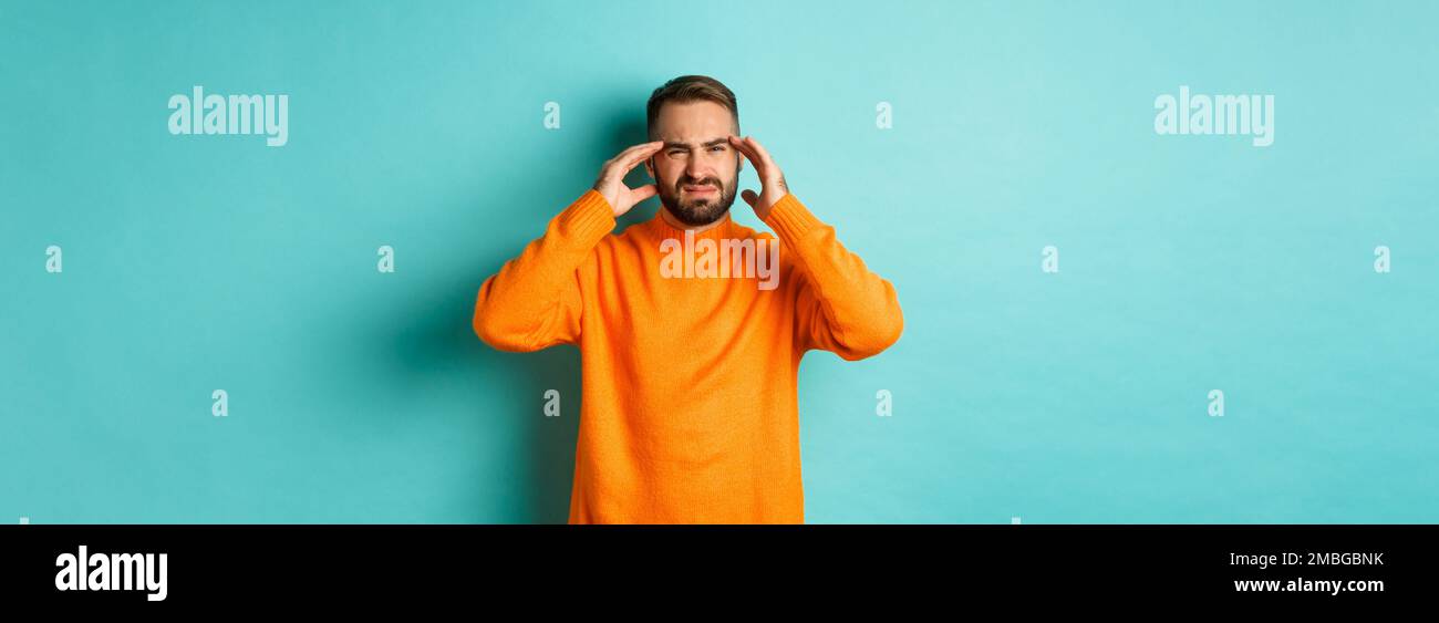 Photo of caucasian man touching head, feeling sick, have headache or ...