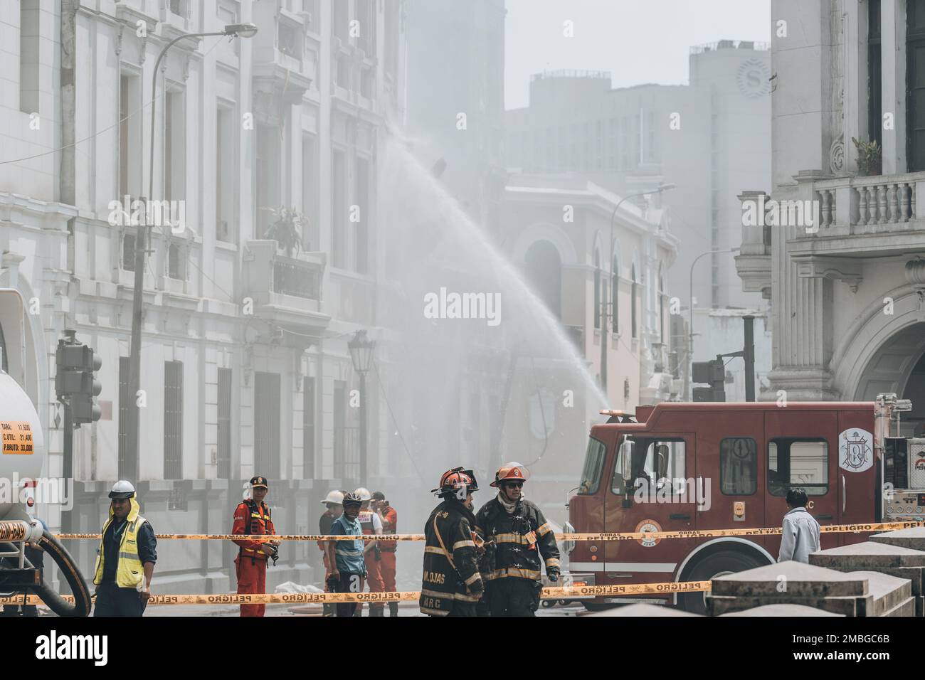 Lima, Peru - January 20 2023: Firefighters trying to control historical ...